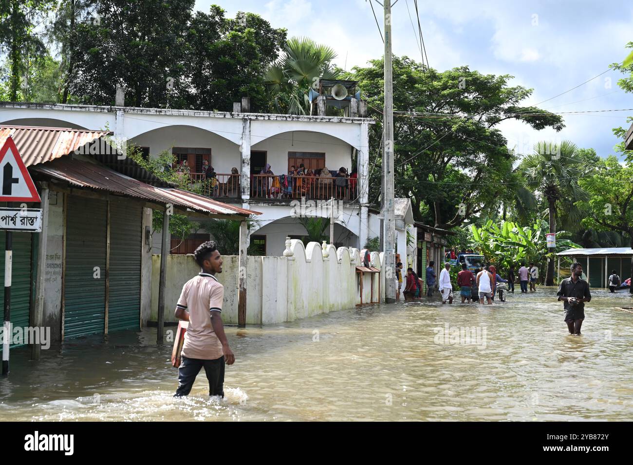 People wade through floodwaters in Feni District, Bangladesh, on August ...