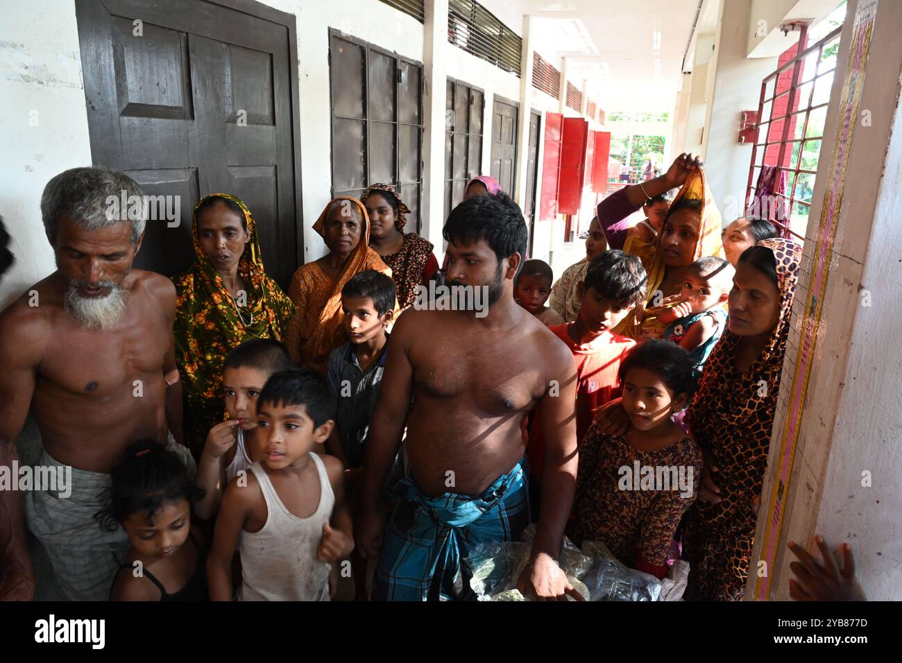 Flood affected peoples are take shelter at a school building in Feni ...