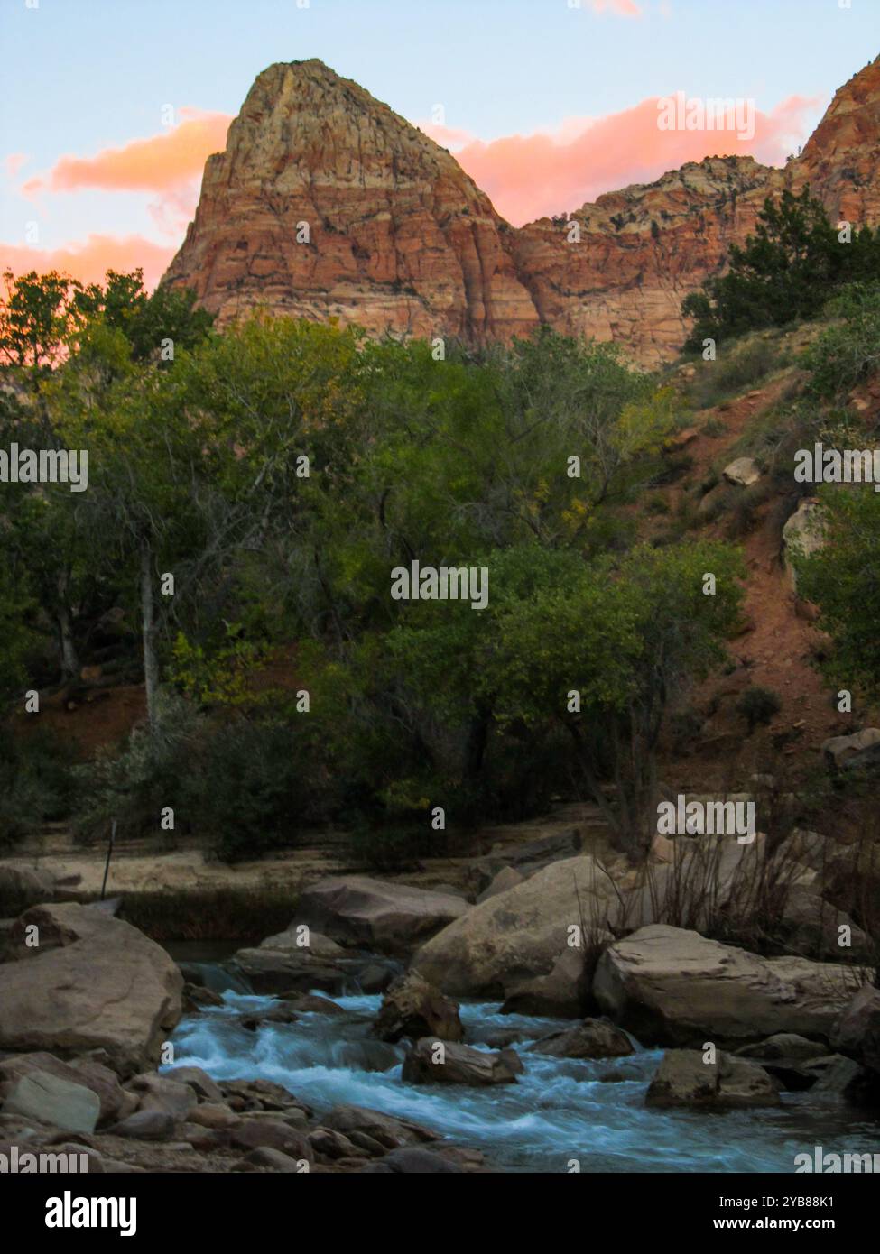 The majestic peak of the Watchman towering over the fast flowing Virgin ...