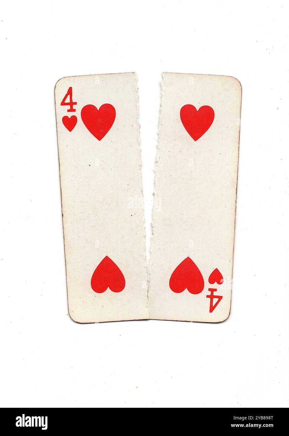 A vintage playing card torn in half from top to bottom on a white ...