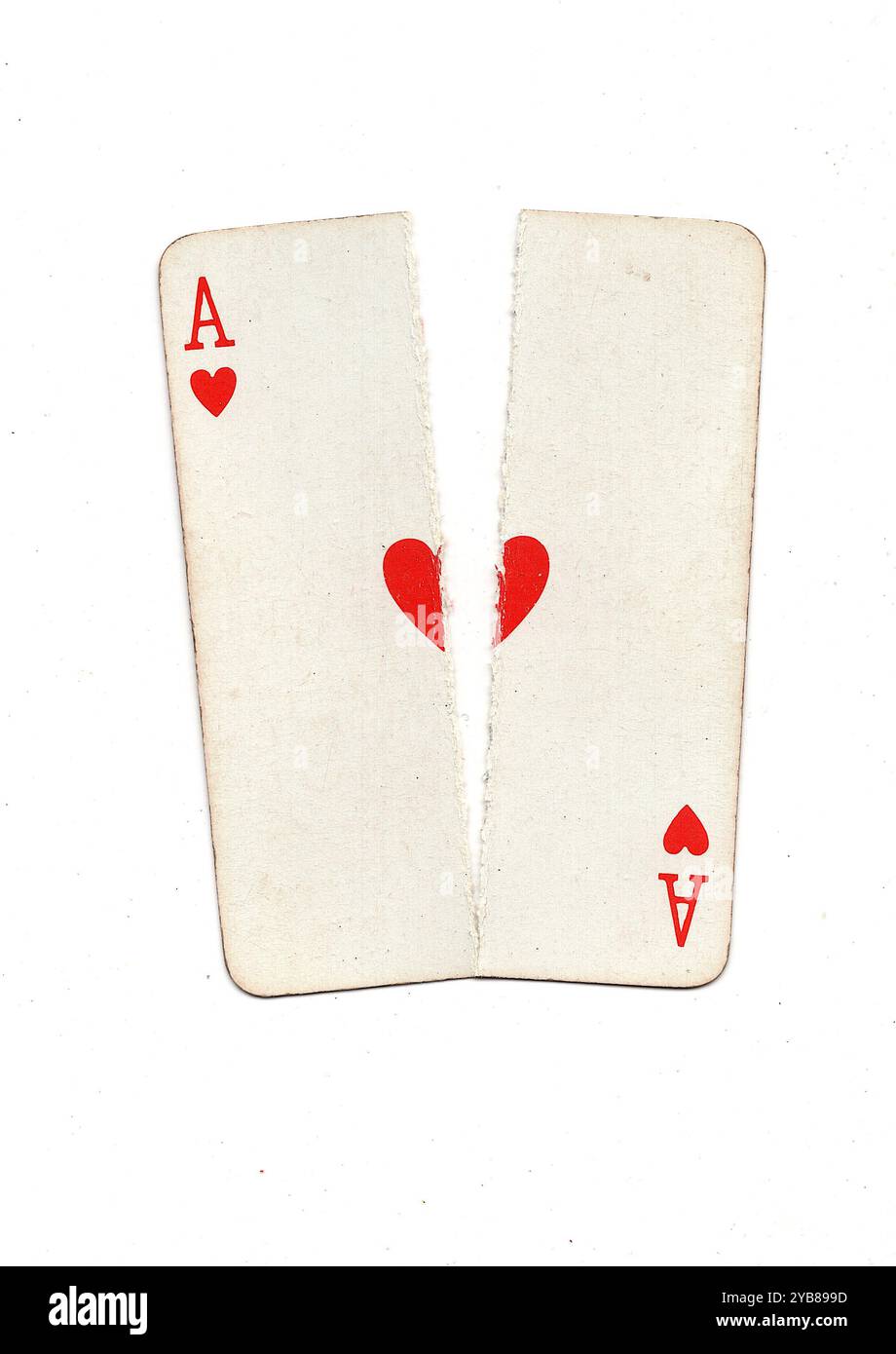 A vintage playing card torn in half from top to bottom on a white ...