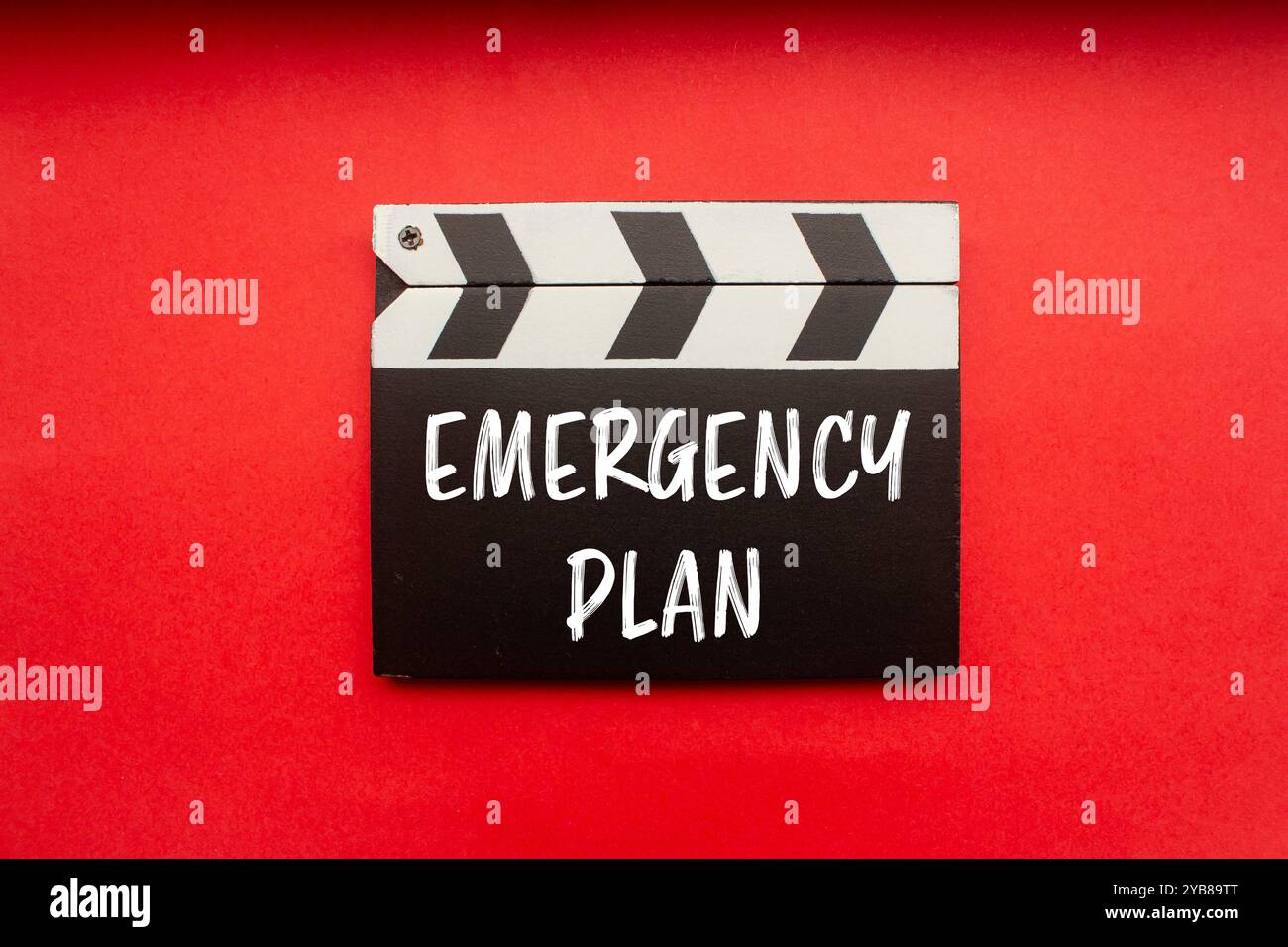 Emergency plan message written on clapperboard with red background ...