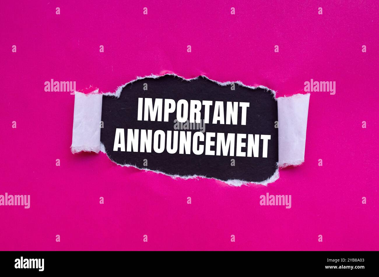 Important announcement message written on ripped pink torn paper with ...