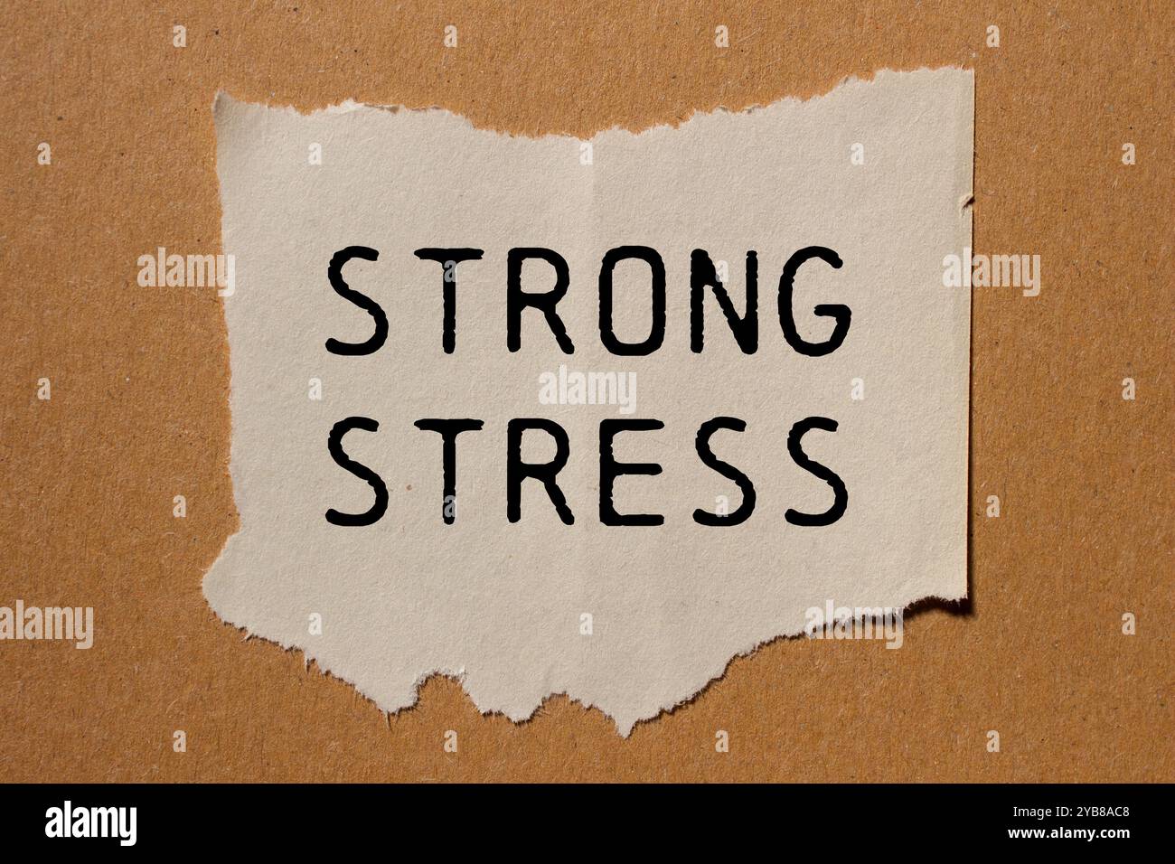 Strong stress message written on ripped torn paper piece with brown ...