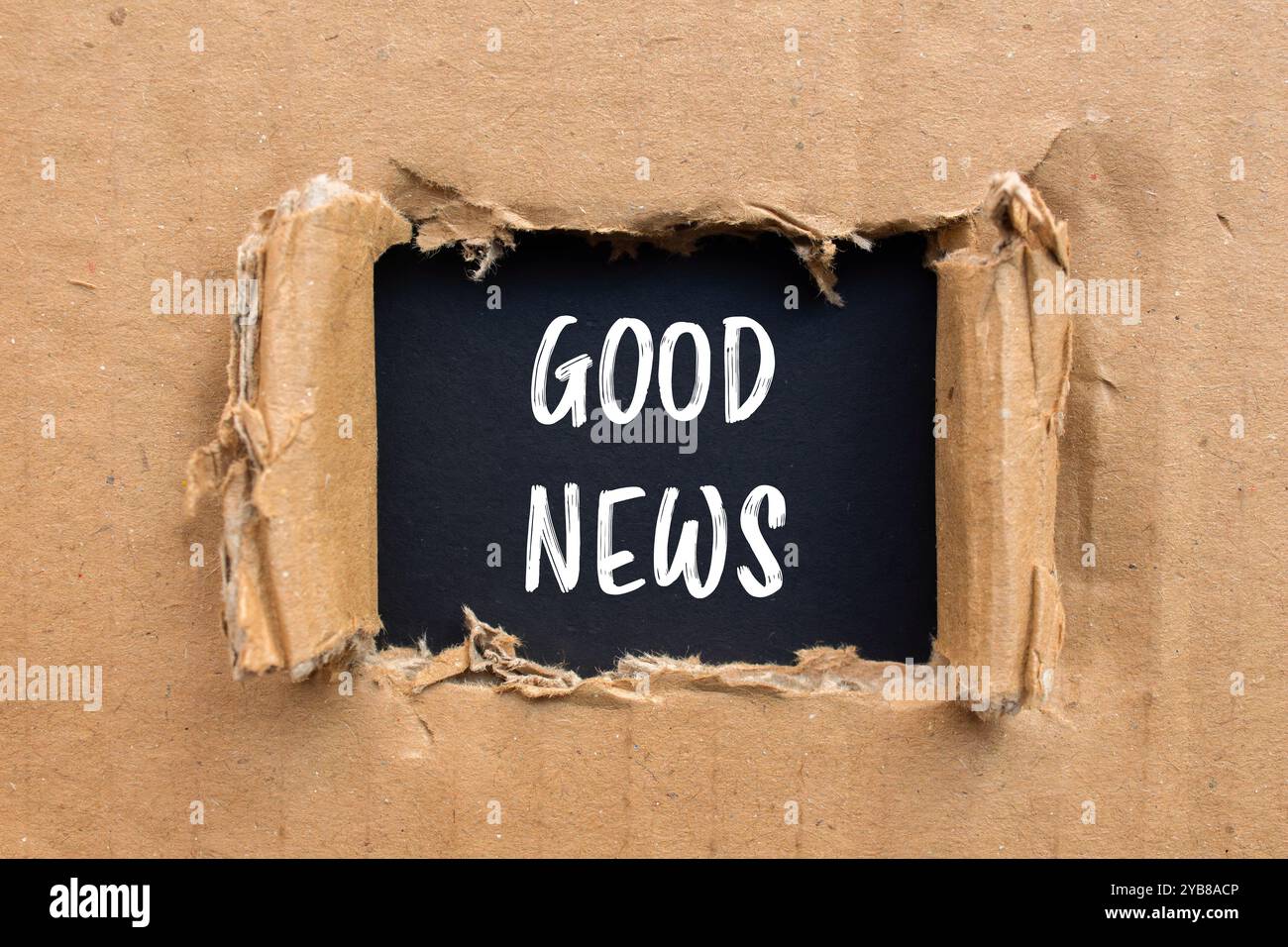 Good news message written on ripped torn cardboard paper with black ...