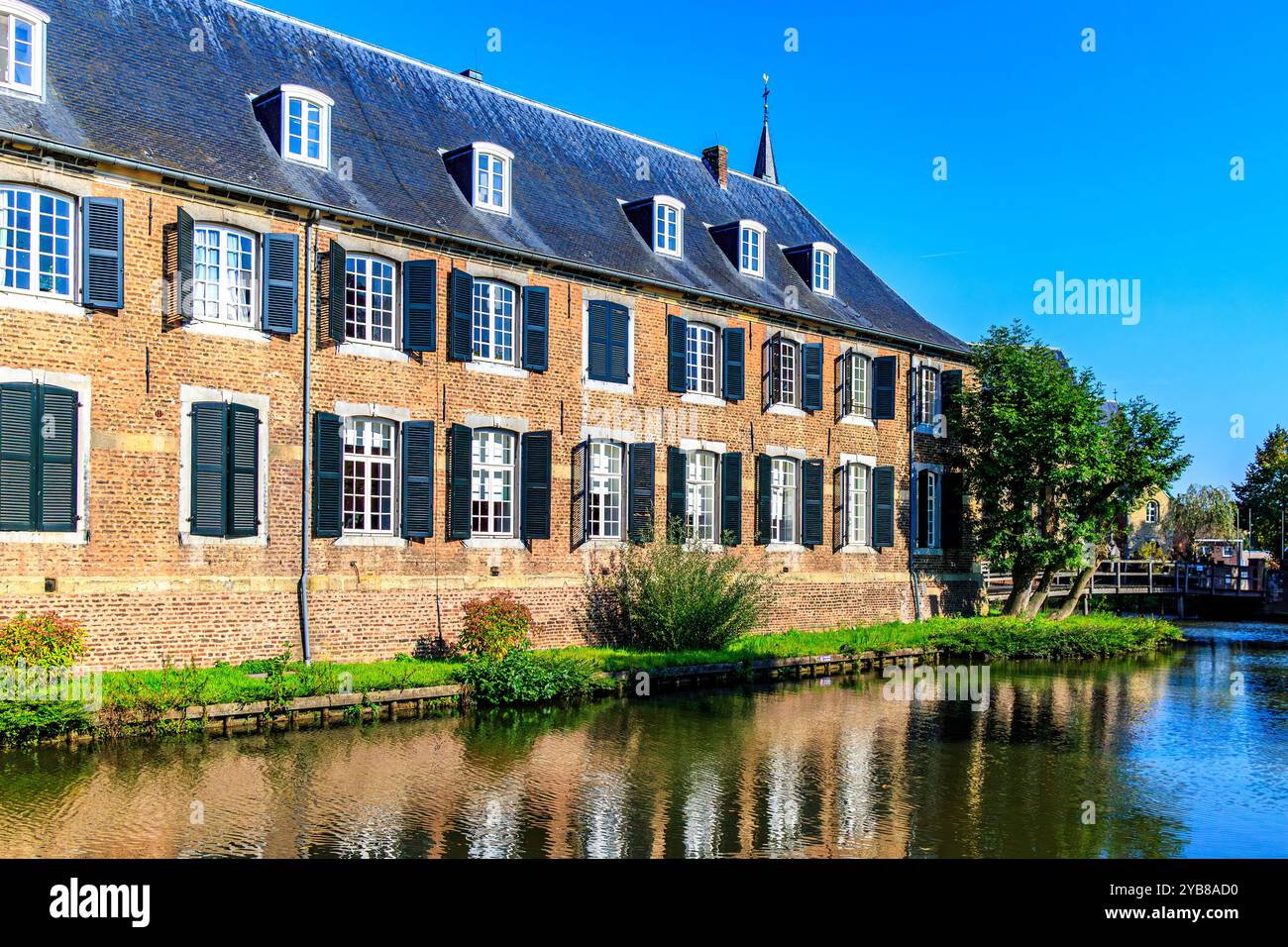Brick wall with multiple windows and gable roof of Wijnandsrade Castle ...