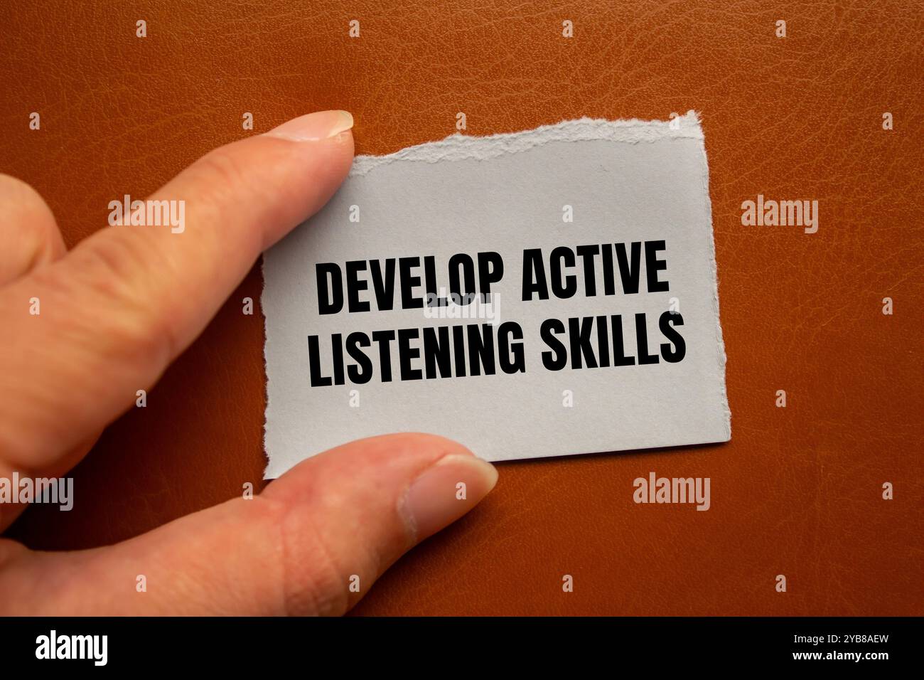 Develop active listening skills message written on ripped torn paper ...