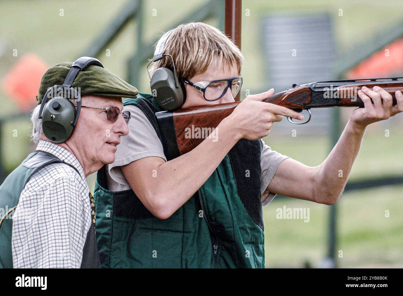 shotgun coach, coaching a teenager how to shoot Stock Photo - Alamy