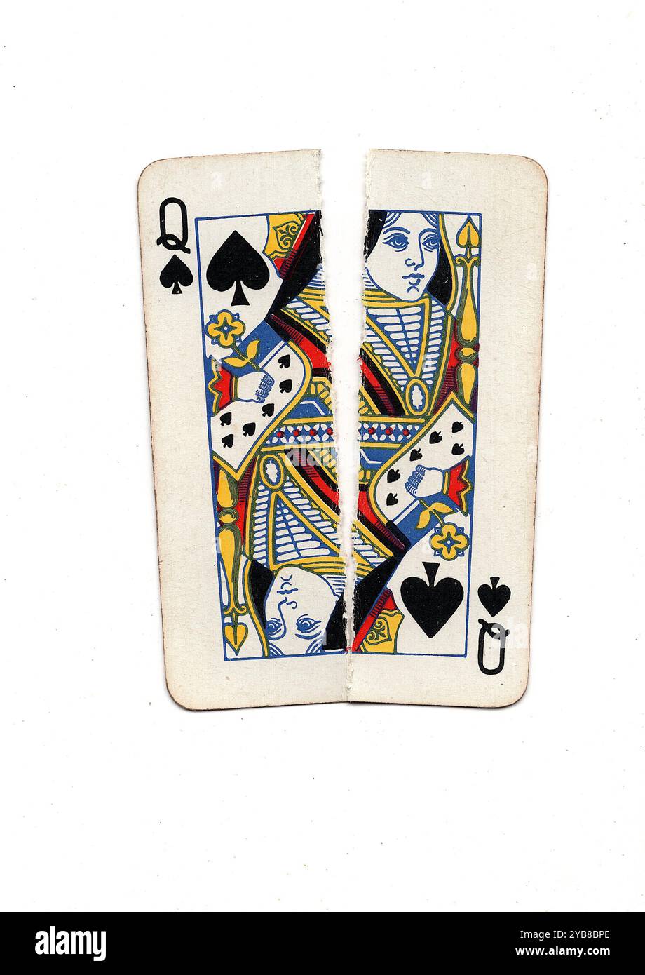 A vintage playing card torn in half from top to bottom on a white ...