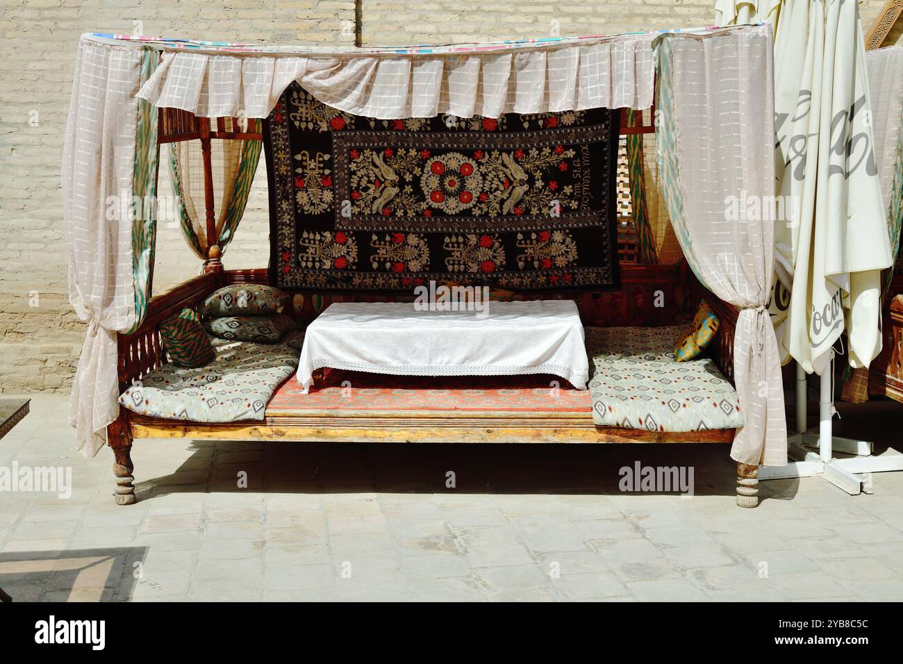 Dastarkhan. Trestle bed with short table with tablecloth used during ...