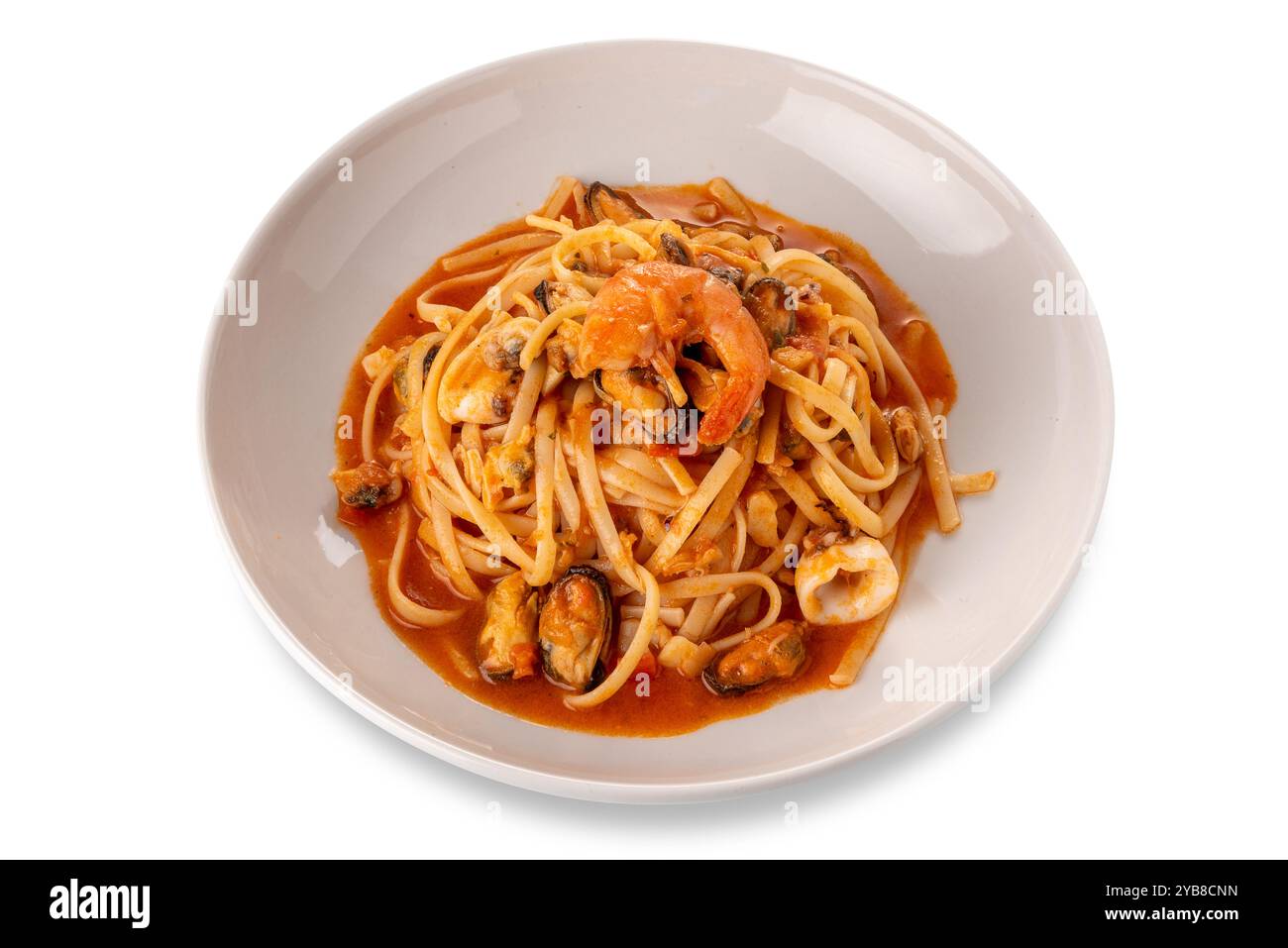 Linguini spaghetti pasta with seafood and tomato sauce in white plate ...