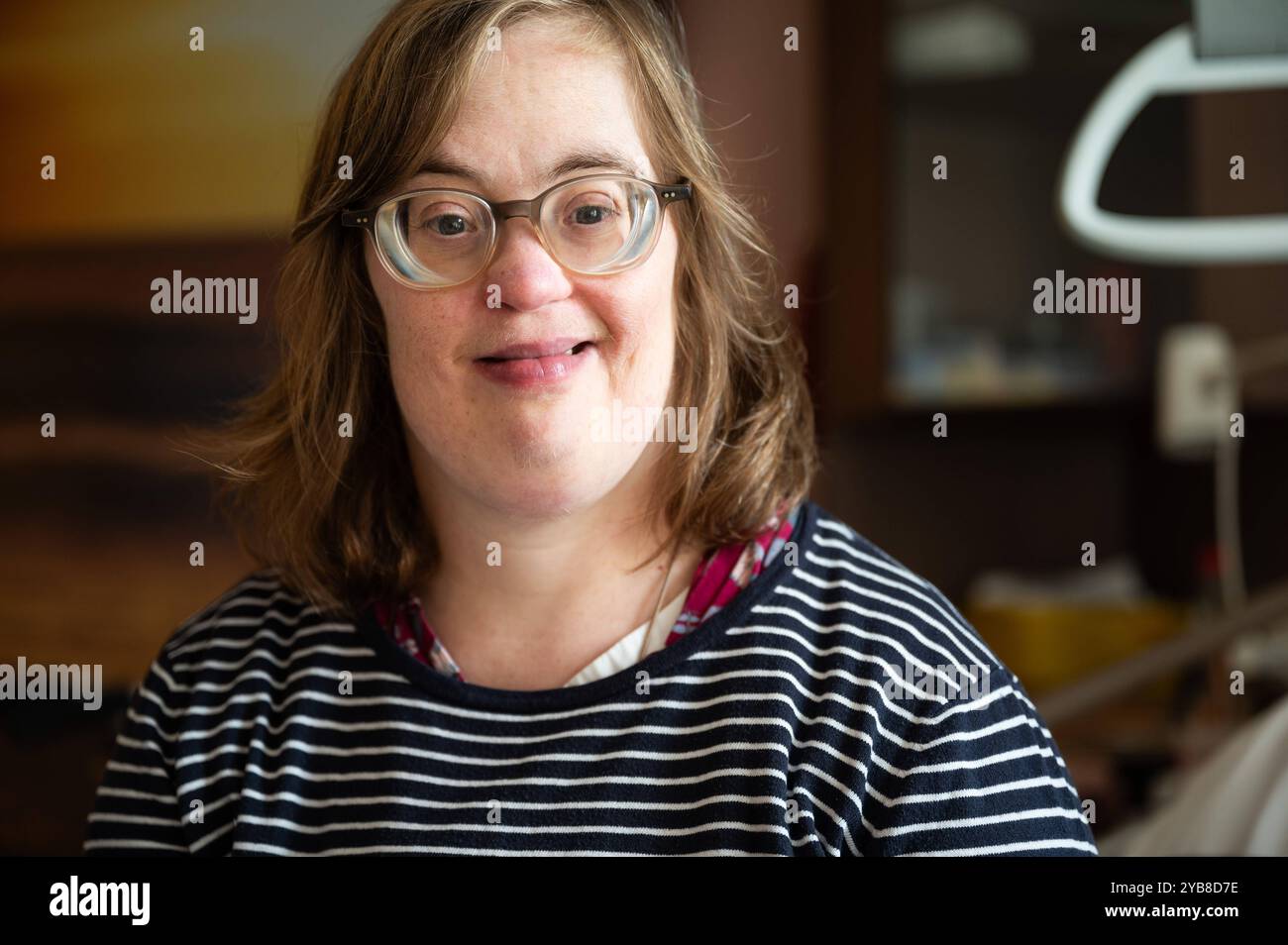 Indoor portrait of a happy 42 yo woman with Down Syndrome, Tienen ...