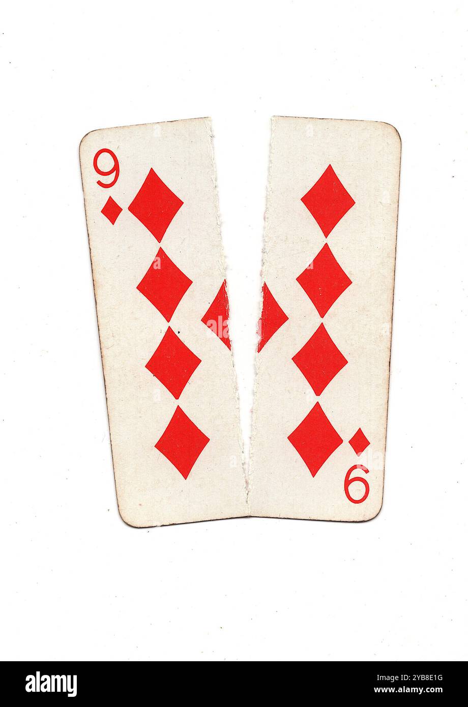 A vintage playing card torn in half from top to bottom on a white ...