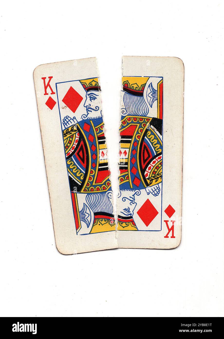 A vintage playing card torn in half from top to bottom on a white ...