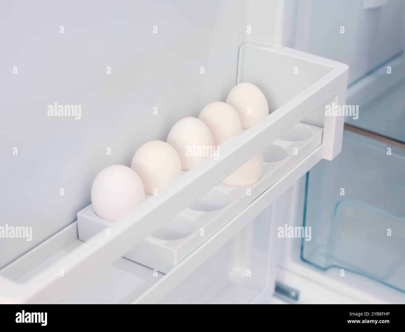 Some eggs in fridge on shelf on the door. Close-up Stock Photo - Alamy