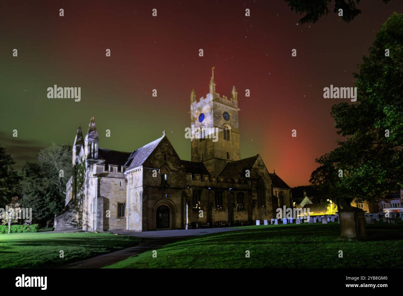 The bright red and green northern lights giving a colourful backdrop to ...