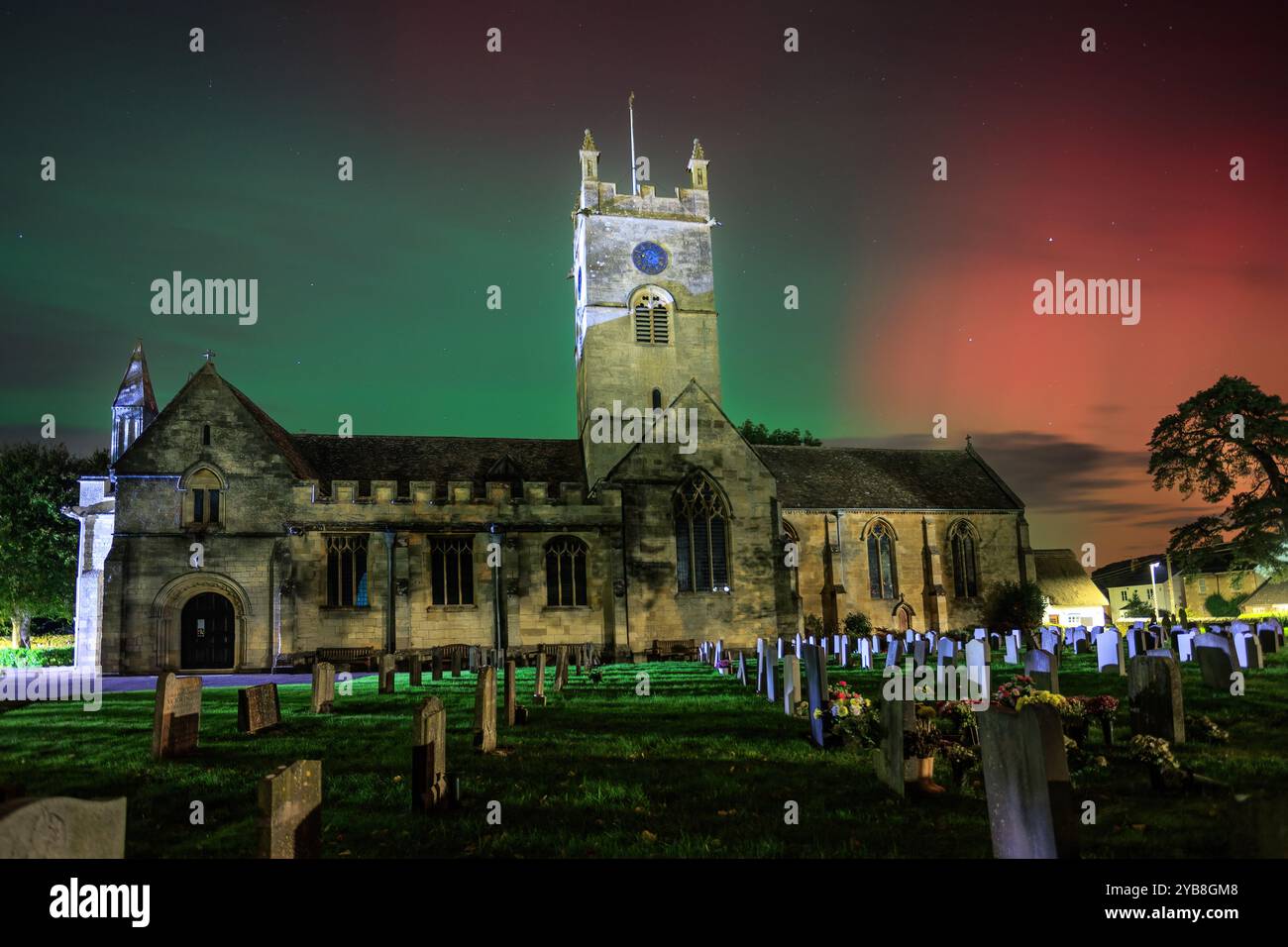 The bright red and green northern lights giving a colourful backdrop to ...