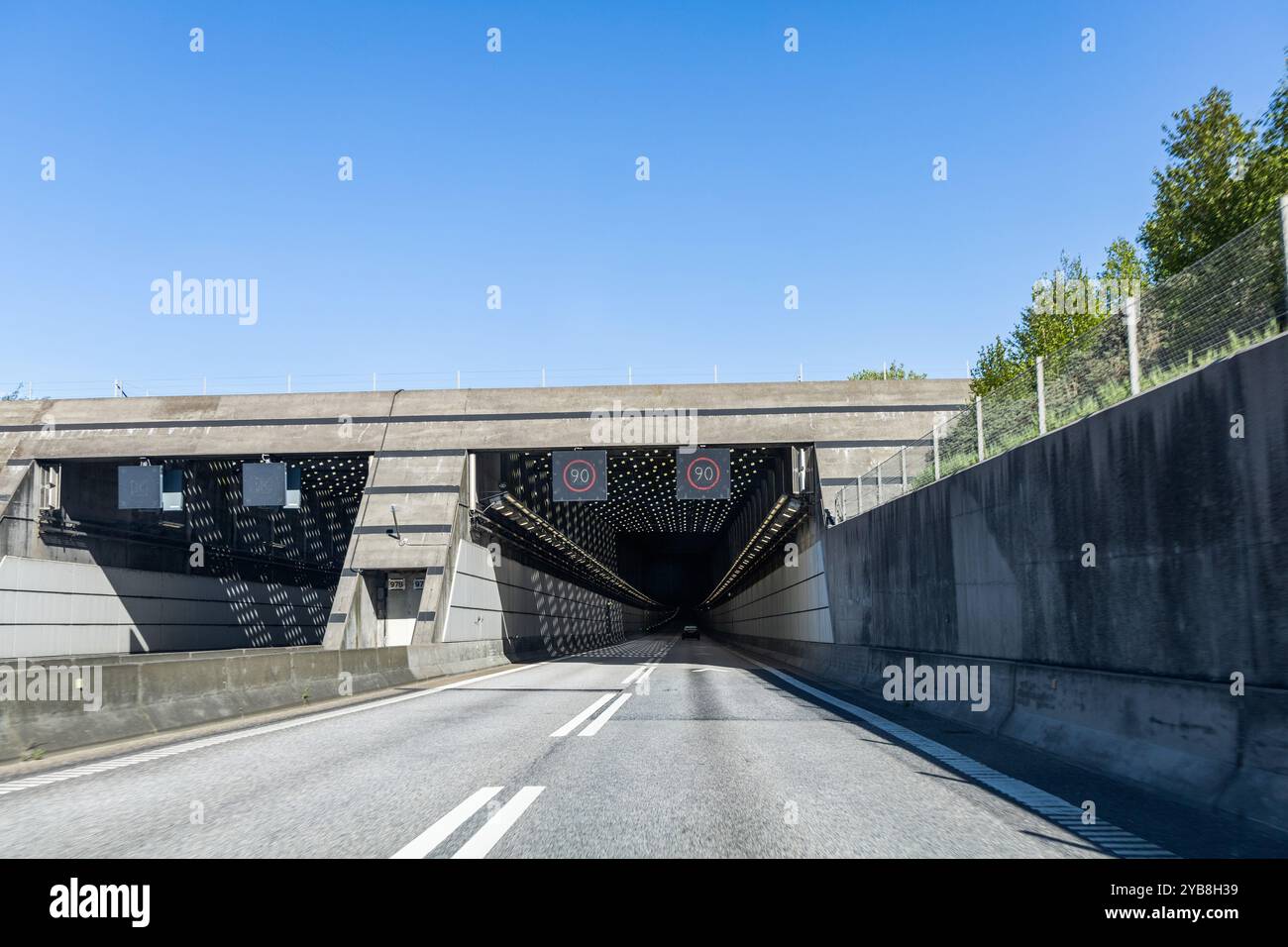 High-speed road tunnel view from a fast-moving car. Road and railway ...