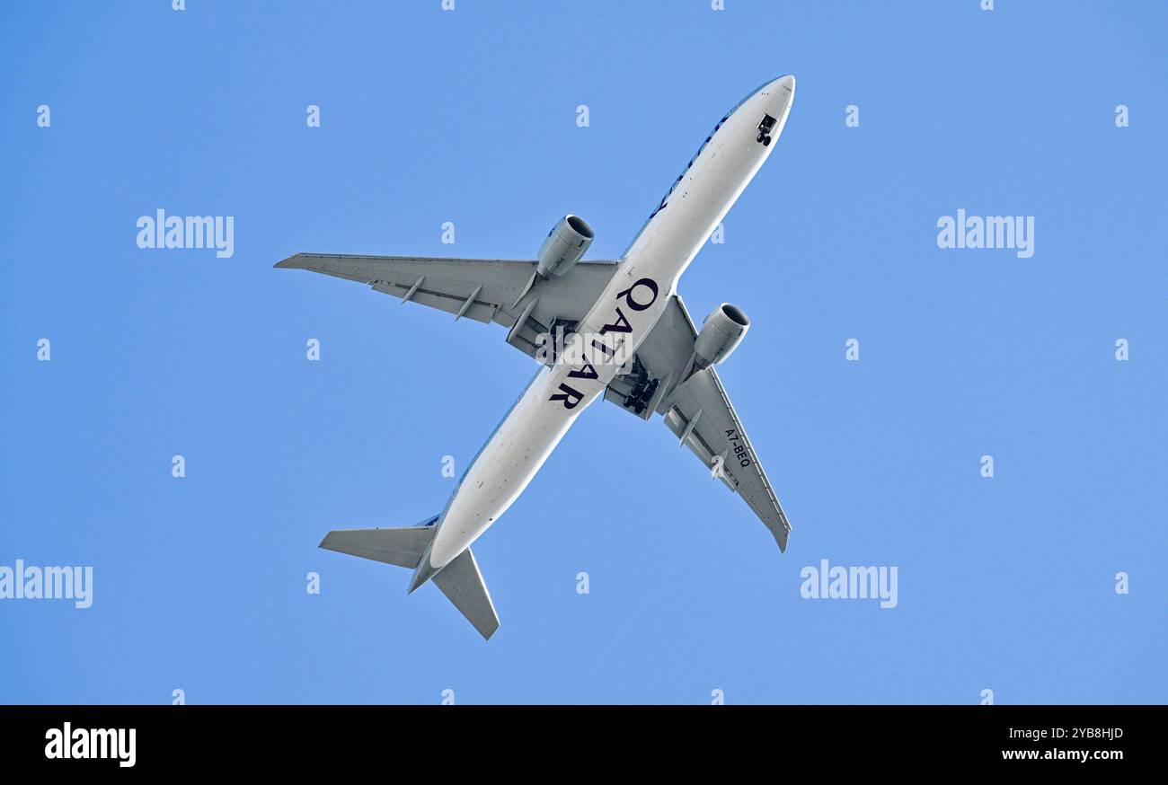 Qatar Airline jet seen from below with blue sky Stock Photo - Alamy