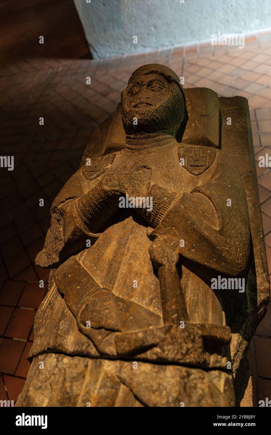 Tomb with a statue of a medieval knight of the walled medieval fortress ...