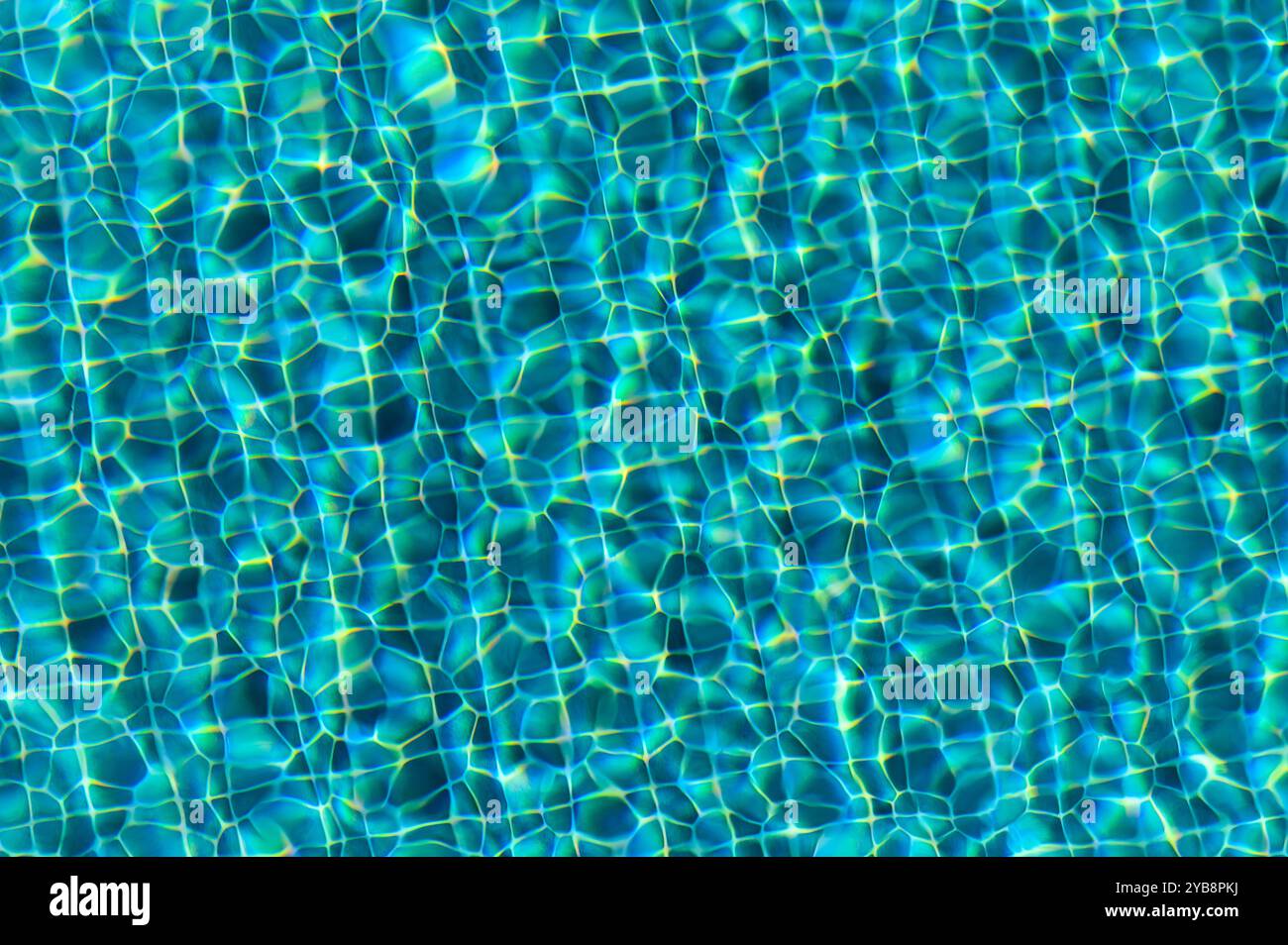 The surface of the water shimmers under bright sunlight, displaying ...