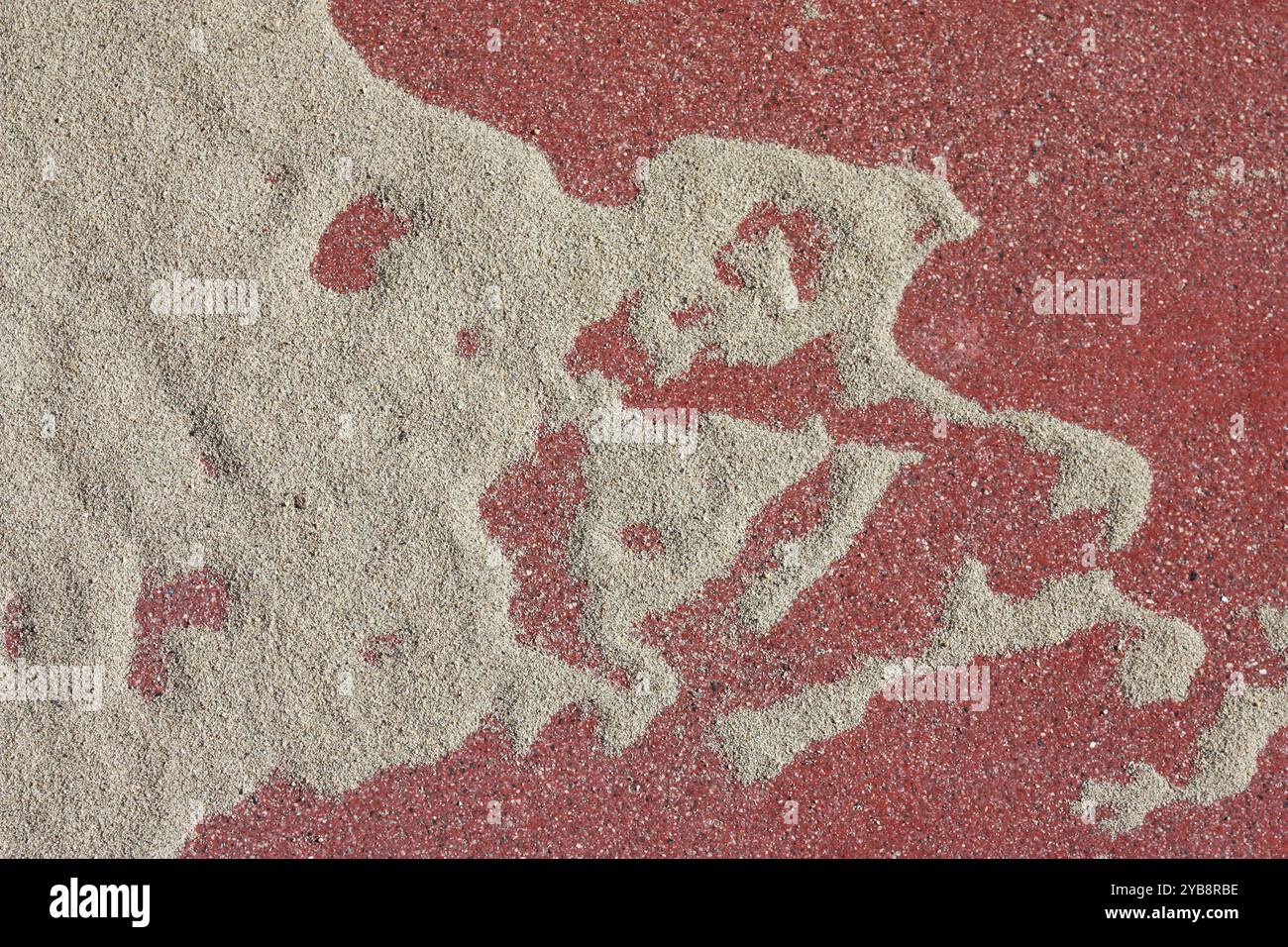 Beach sand blown onto red payment by the wind Stock Photo - Alamy