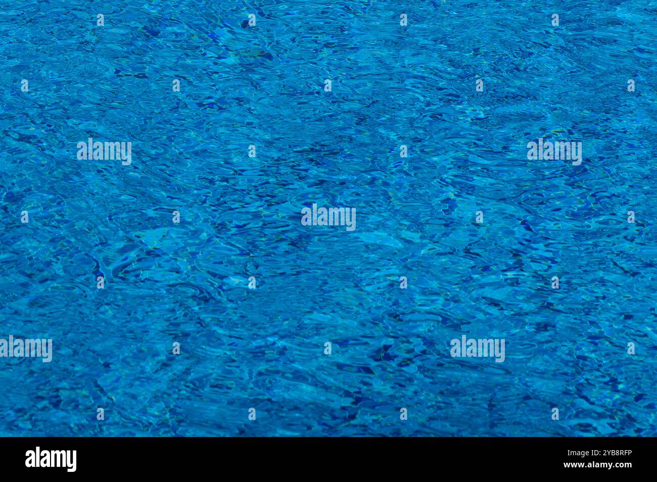 The vibrant blue water reflects sunlight, creating a serene atmosphere ...