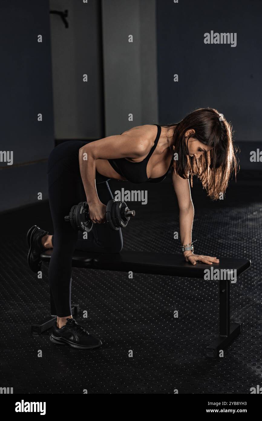 Focused Fitness A Woman Engaging in Strength Training with a Dumbbell ...