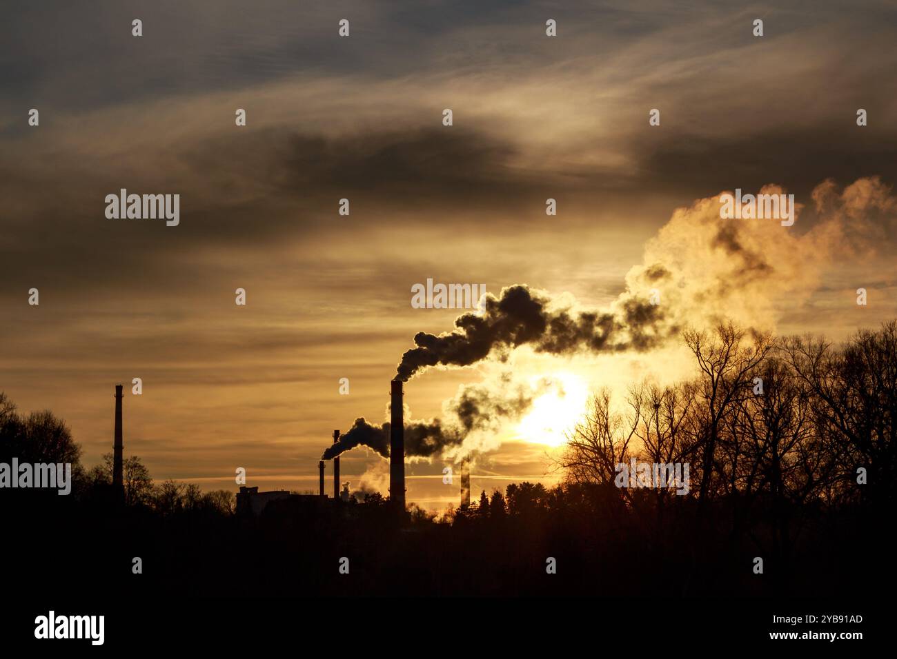Smoking factory chimneys against colorful sunset, industrial landscape ...