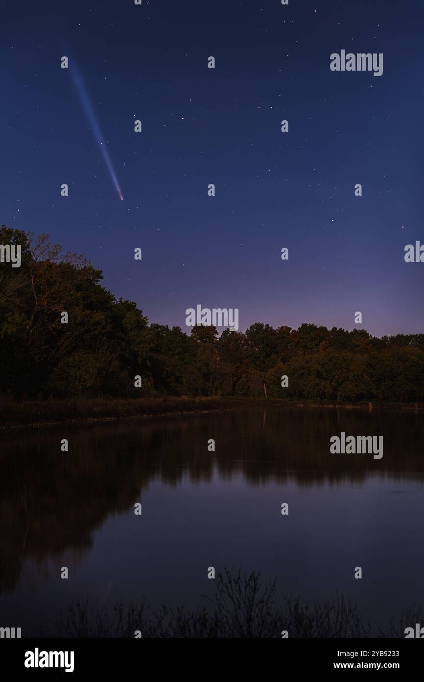 Vertical Vew of comet over Midwestern lake; woods around the lake; full ...