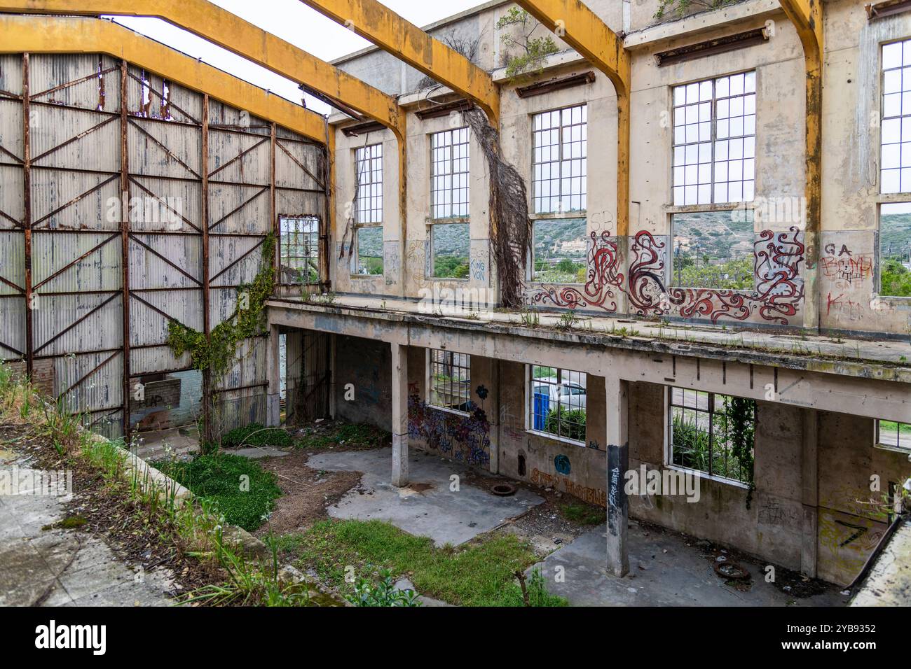 A view inside the abandoned derelict power station with overgrown ...