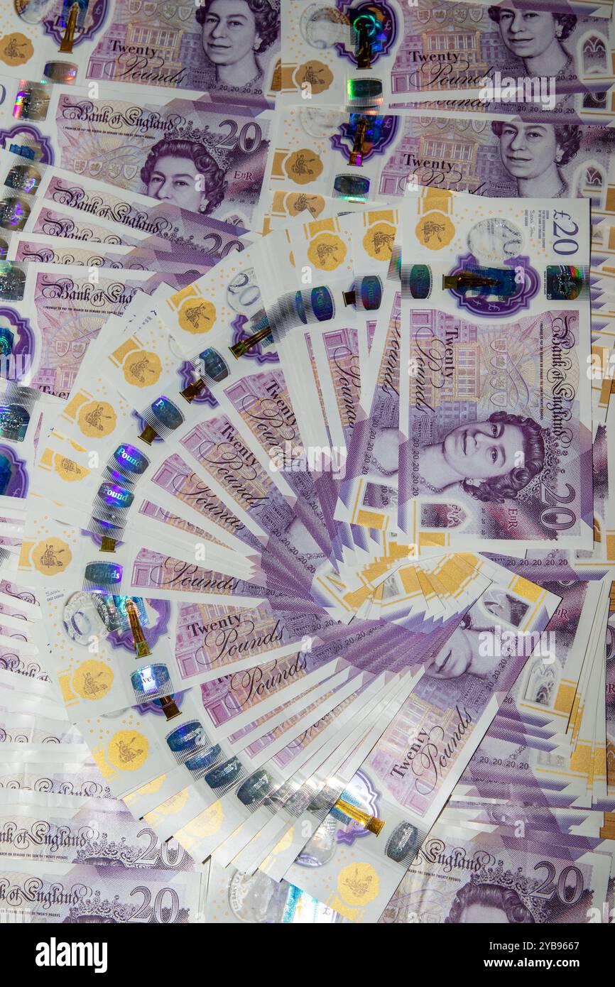 A fan of twenty-pound banknotes arranged in a spiral pattern ...