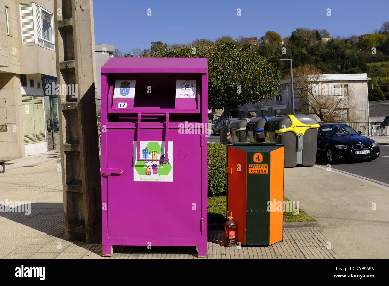 textiles and cooking oil disposal containers in Spain Stock Photo - Alamy