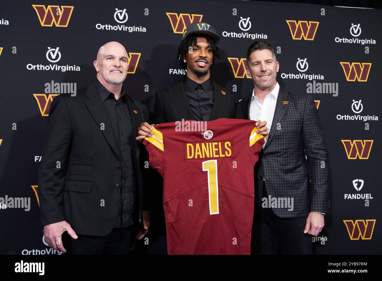 FILE - Washington Commanders' first round draft pick Jayden Daniels holds his Commanders jersey ...