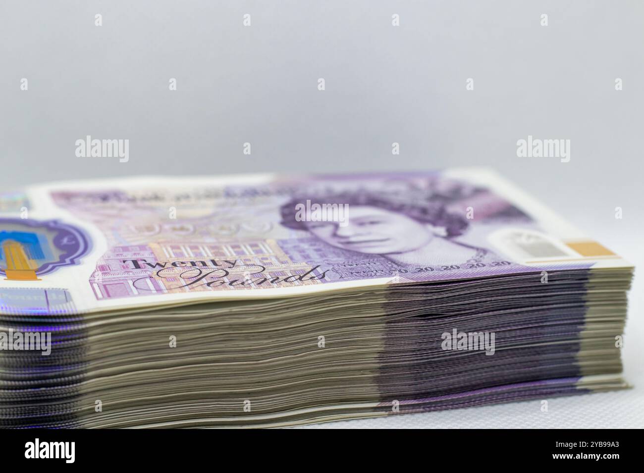 A close-up view of a stack of twenty-pound banknotes, showcasing the ...