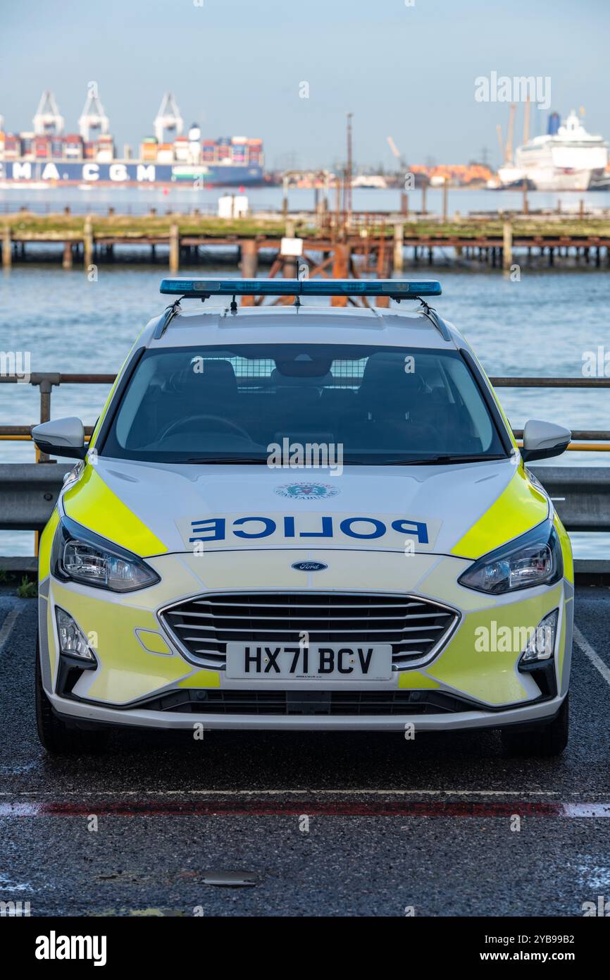 modern police car with decals and blue lights parked at the waterside ...