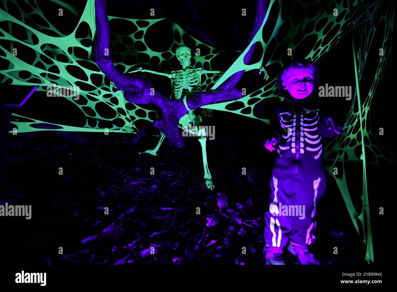 A boy poses besides lights installations featuring skeleton during the ...