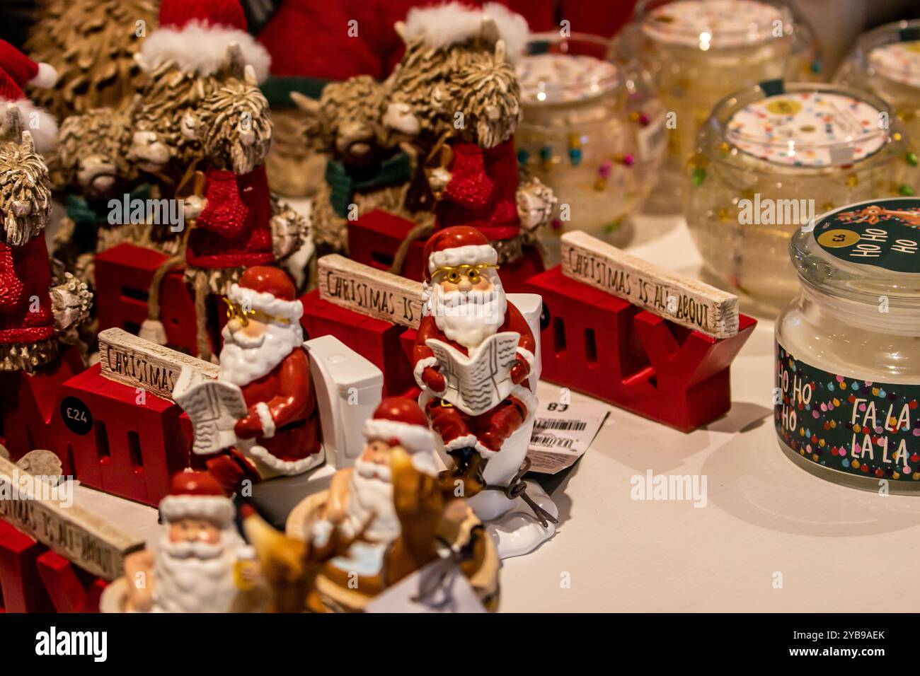A festive display of Christmas decorations featuring Santa figurines ...