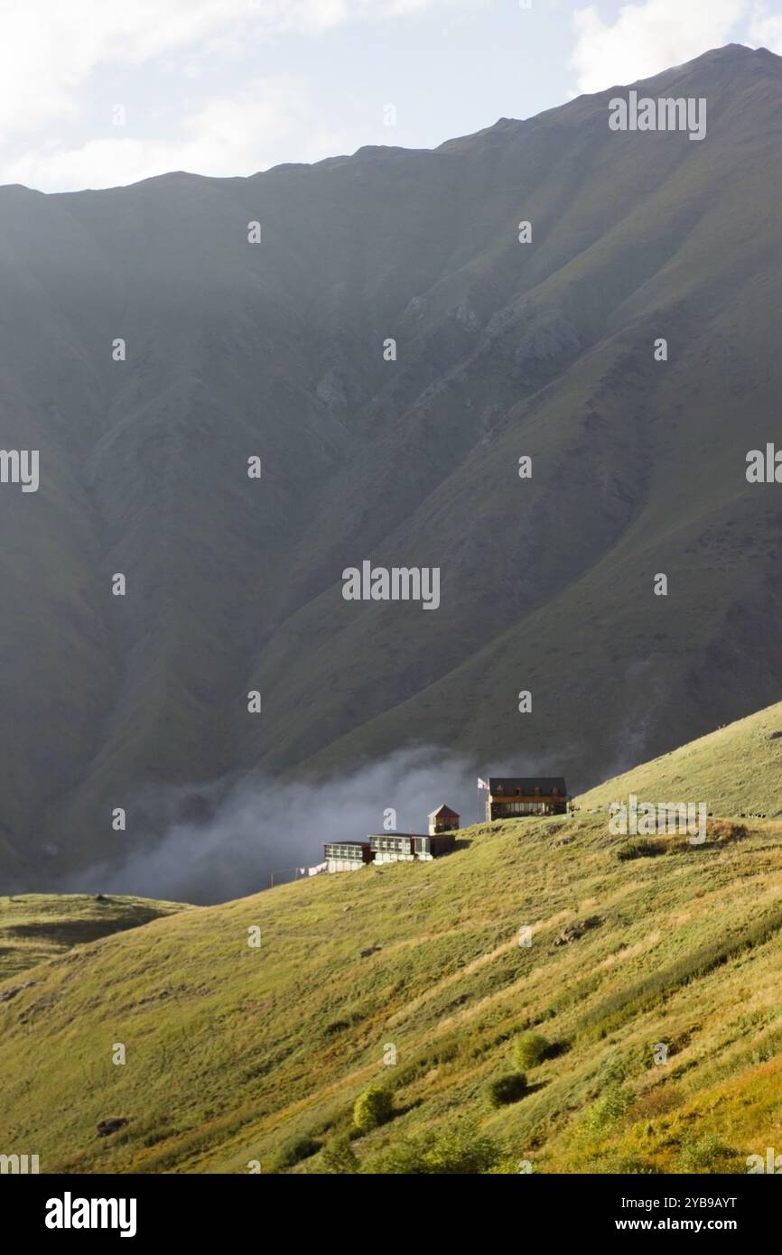 a peaceful, remote mountain setting, featuring towering green and rocky ...