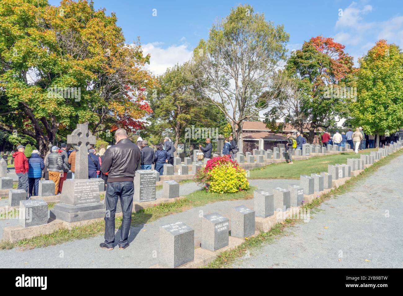 Visitors file past the graves of over 100 victims of the Titanic ...