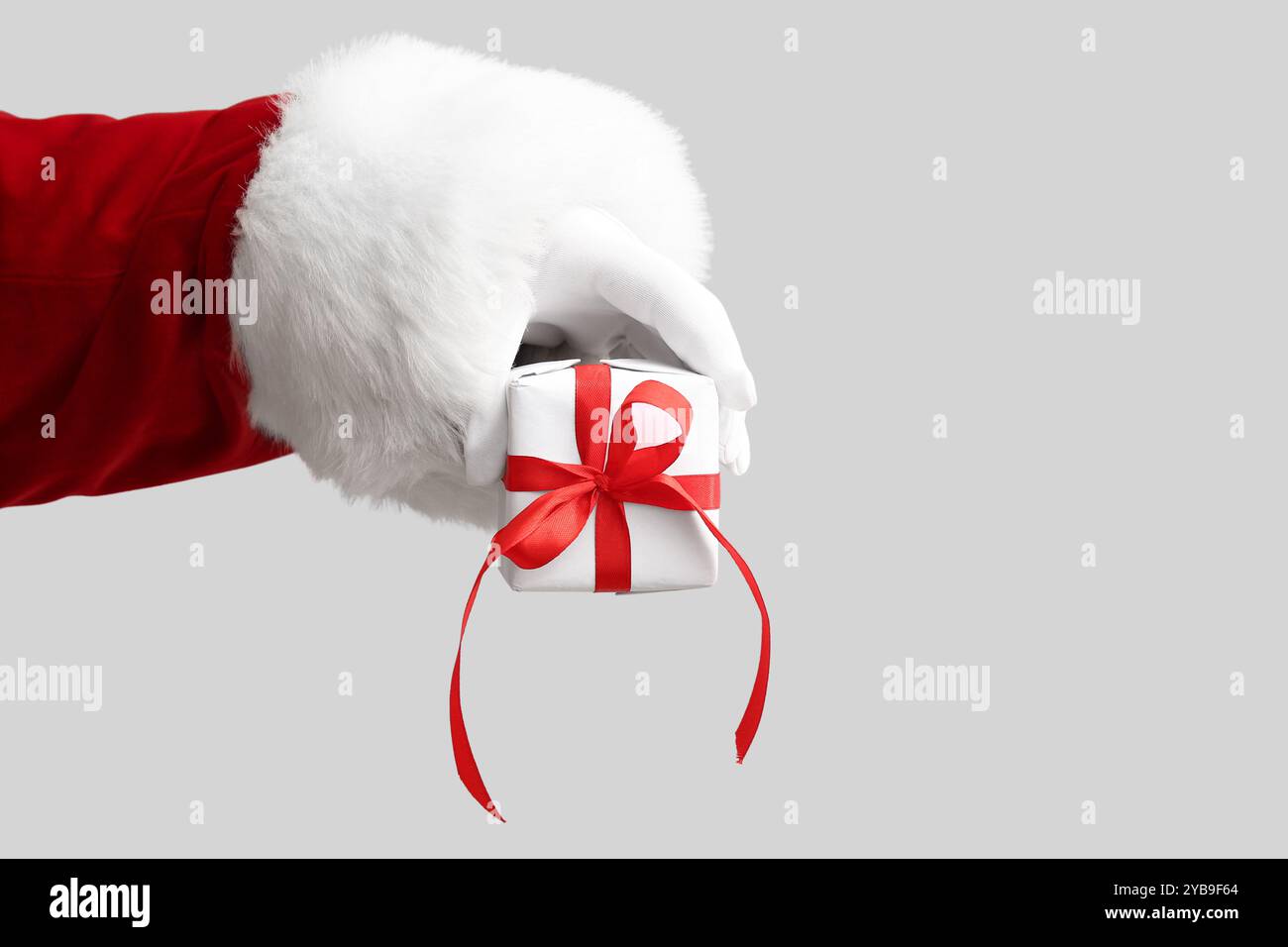 Santa Claus with gift box on white background Stock Photo - Alamy
