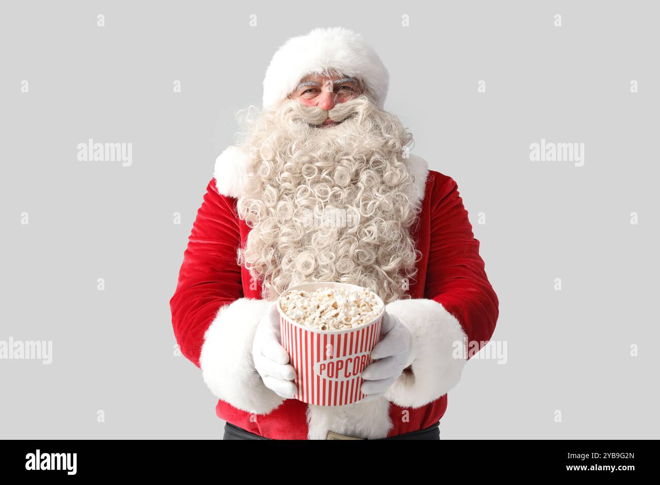 Santa Claus with tasty popcorn on white background Stock Photo - Alamy