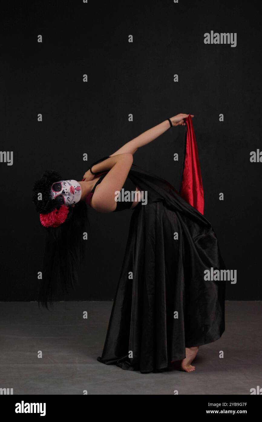 Dancer woman with skull makeup dances to celebrate the Day of the Dead ...