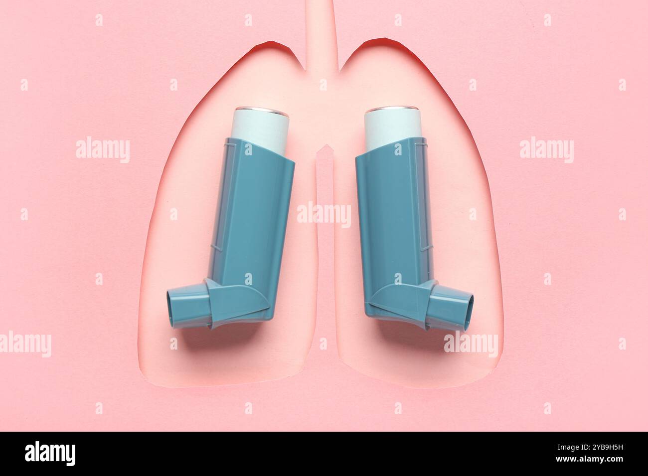 Inhalers and paper lungs on pink background, closeup Stock Photo - Alamy