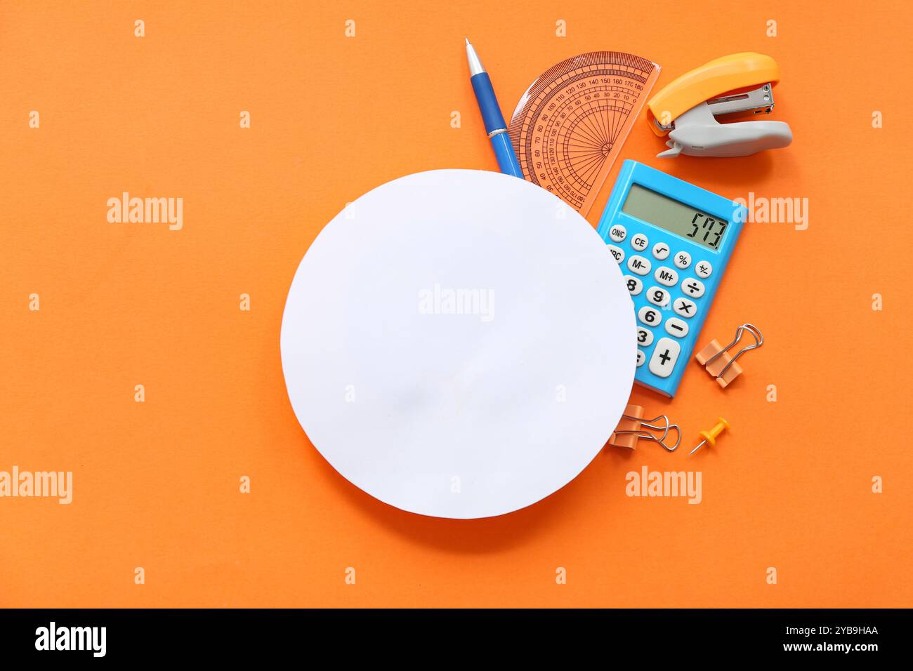Round blank paper sheet with calculator and school stationery on orange ...