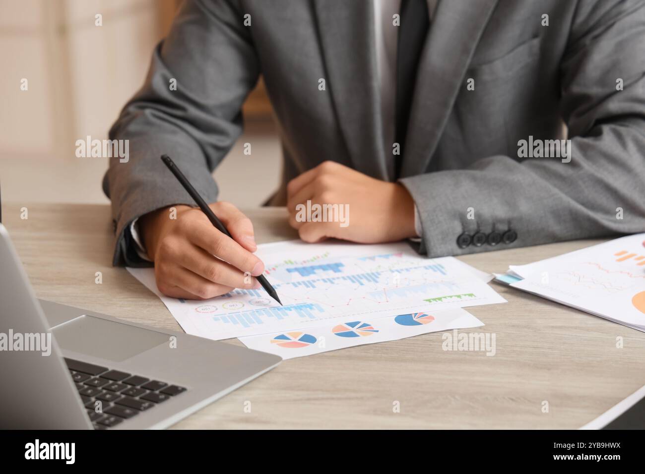 Male economist working with diagrams at desk in office, closeup Stock ...