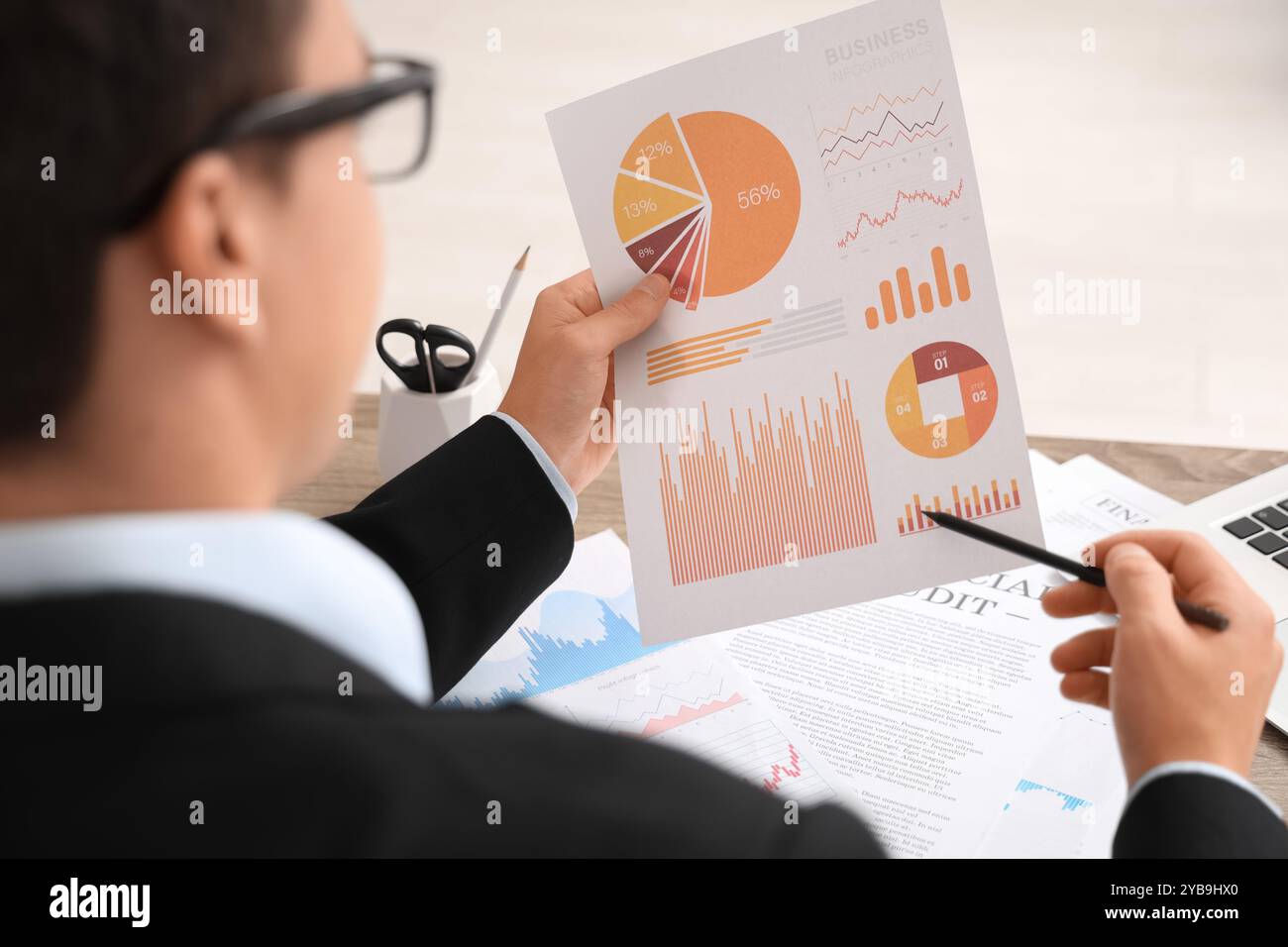 Male economist working with diagrams in office, closeup Stock Photo - Alamy