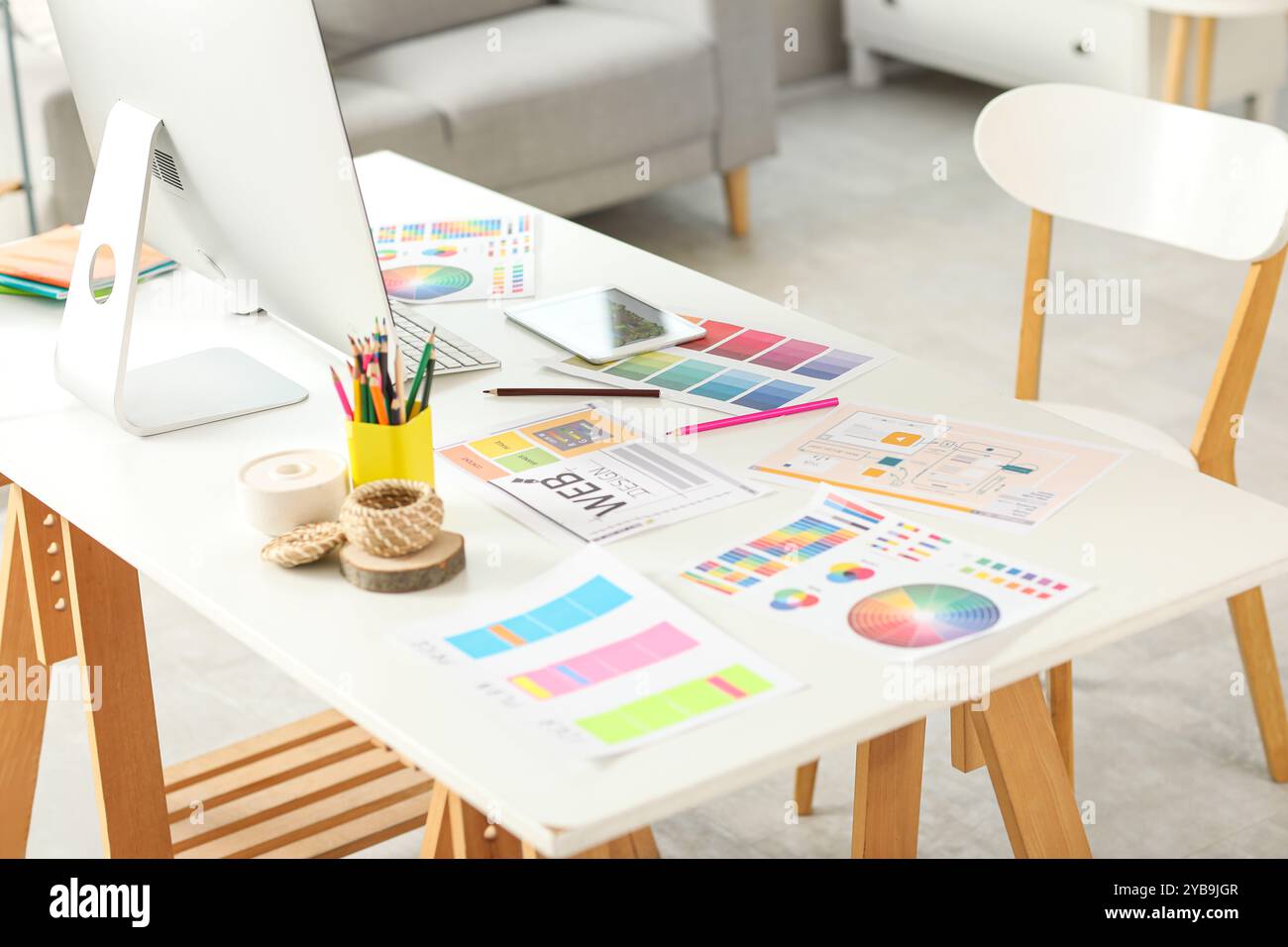 Graphic designer's workplace with computer and color palettes in office ...