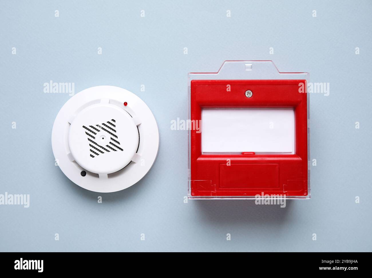Modern smoke detector with fire call point on grey background Stock ...