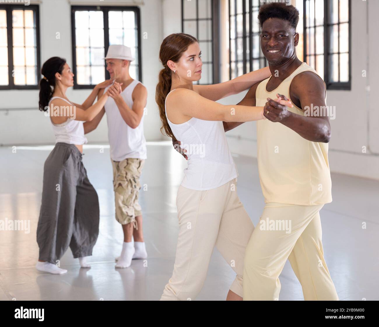 Four dancers exercising bachata movements Stock Photo - Alamy